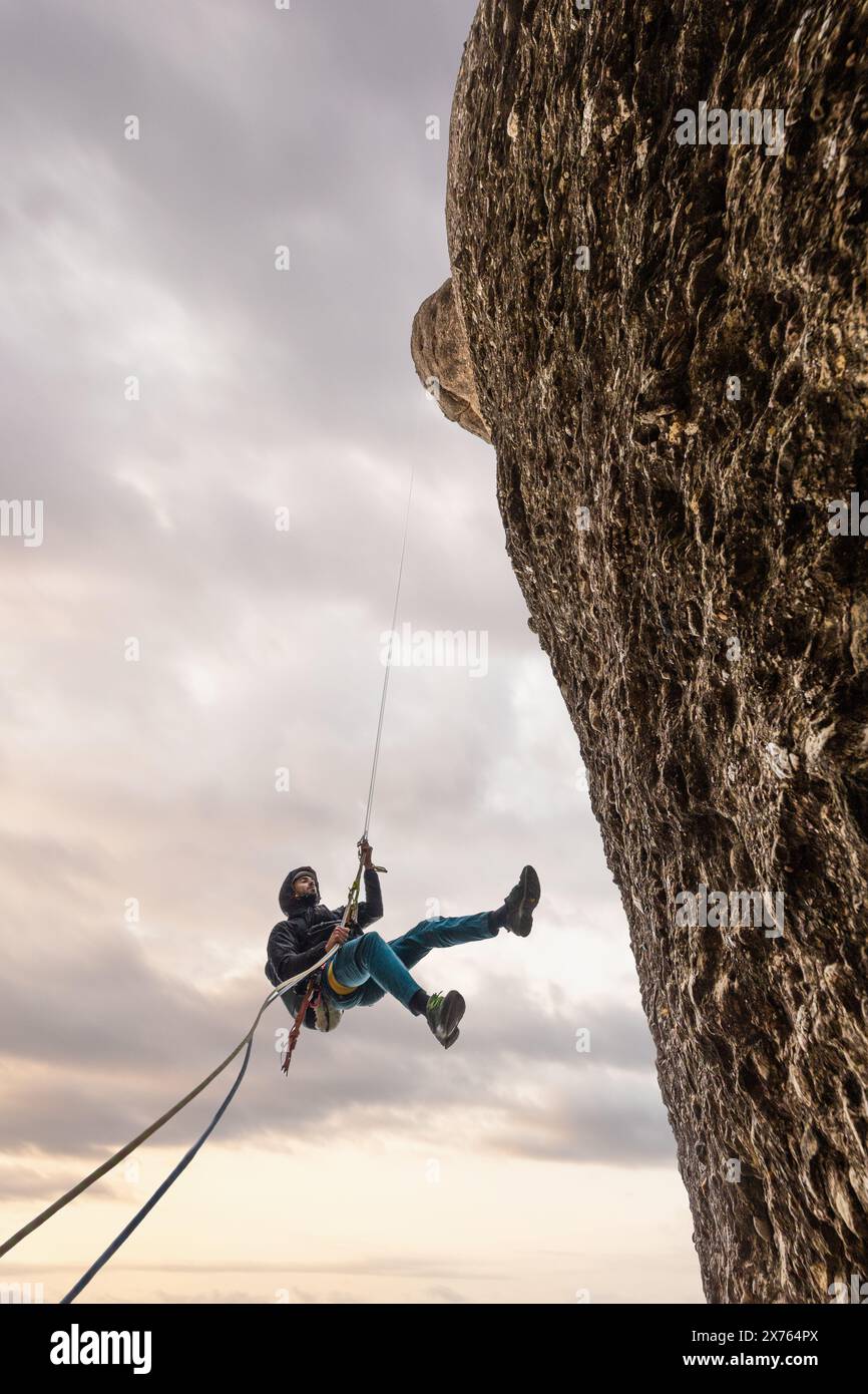 boy climbing on the mountain, boy rappelling on the mountain, enjoy ...