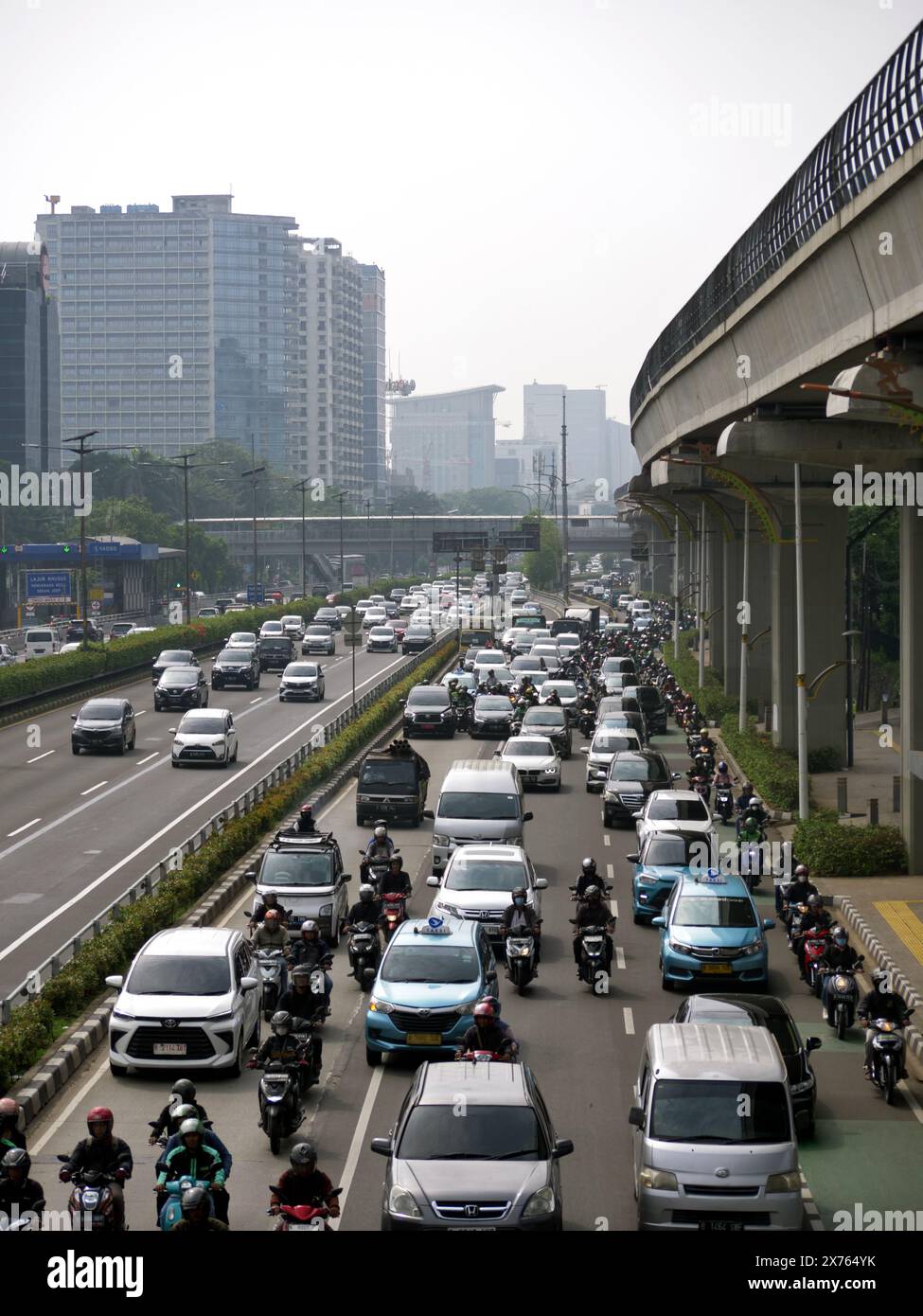 Jakarta, Indonesia-May 10, 2024: Busy traffic with chaotic vehicles scrambling on the highway ...