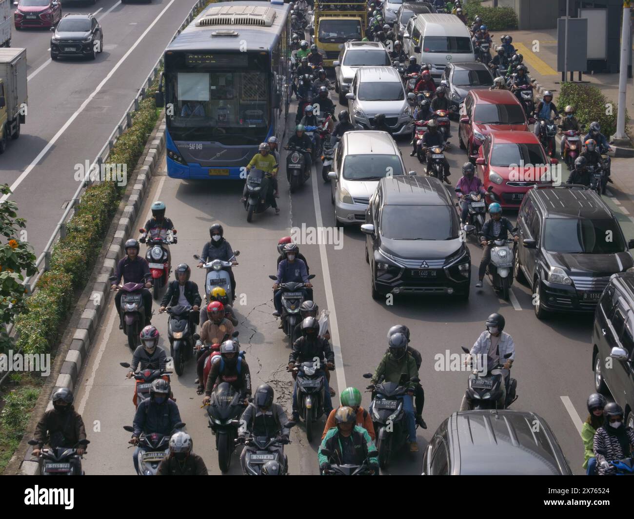Jakarta, Indonesia-May 10, 2024: Busy traffic with chaotic vehicles scrambling on the highway ...