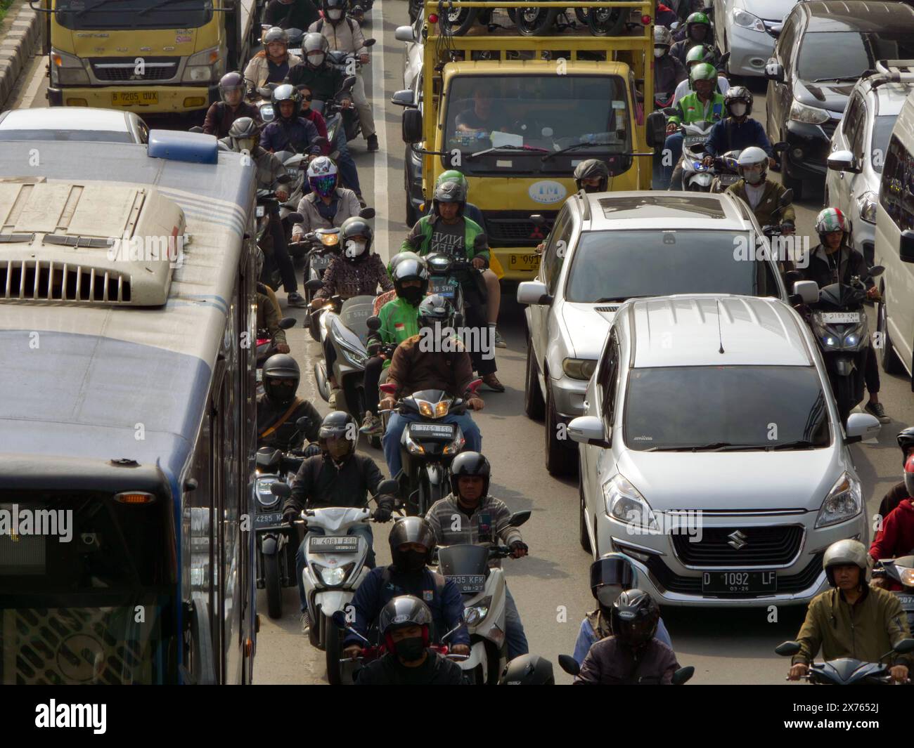Jakarta, Indonesia-May 10, 2024: Busy traffic with chaotic vehicles scrambling on the highway ...