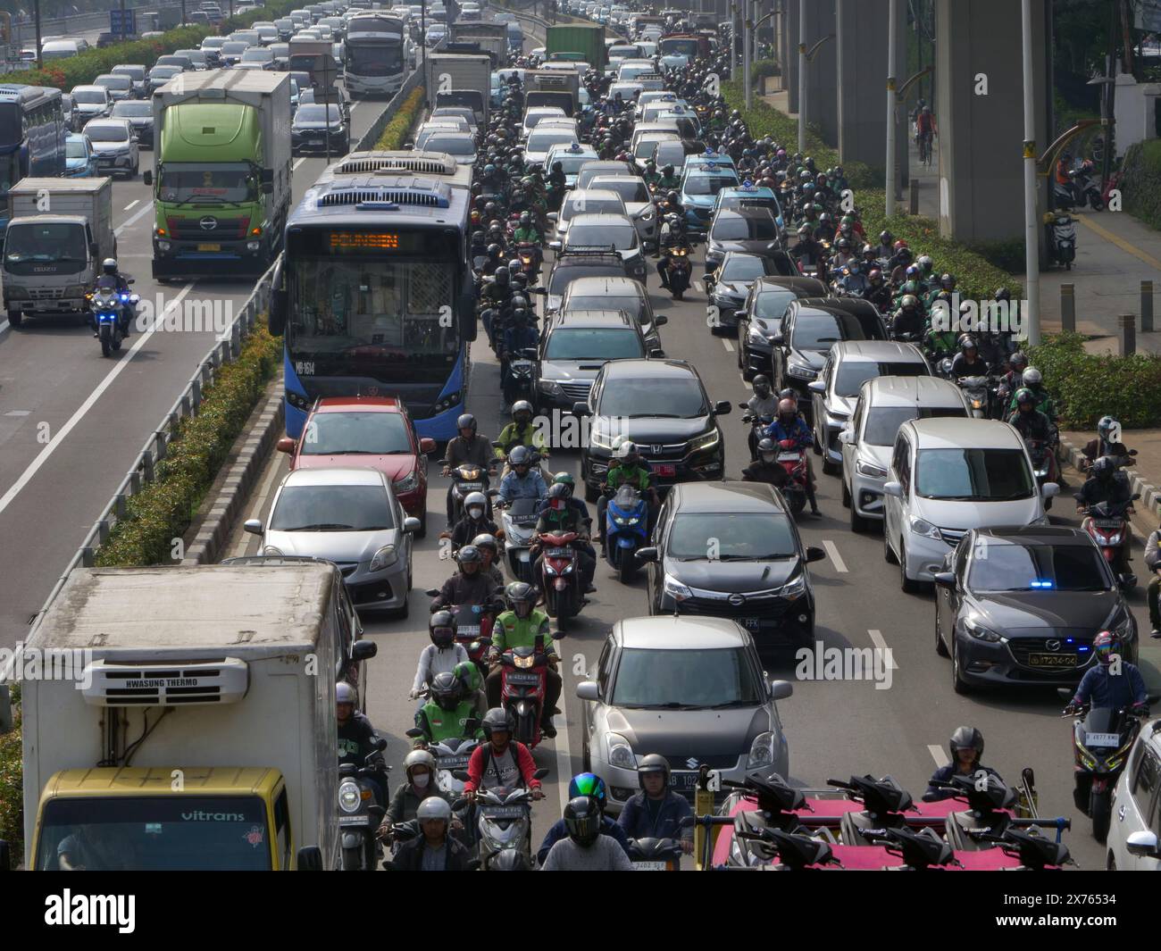 Jakarta, Indonesia-May 10, 2024: Busy traffic with chaotic vehicles scrambling on the highway ...