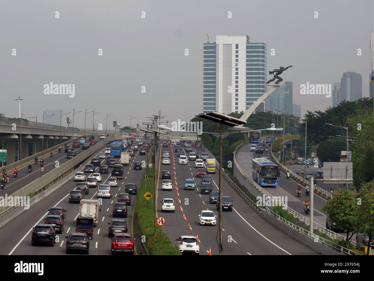 Jakarta, Indonesia-May 10, 2024: Busy traffic with chaotic vehicles scrambling on the highway ...