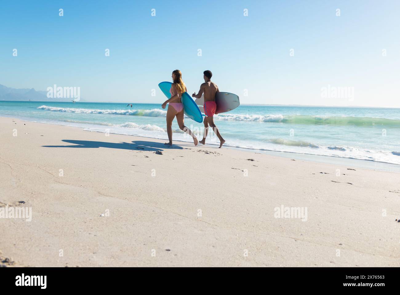 At Beach Diverse Couple Holding Surfboards Walking On Sand Stock