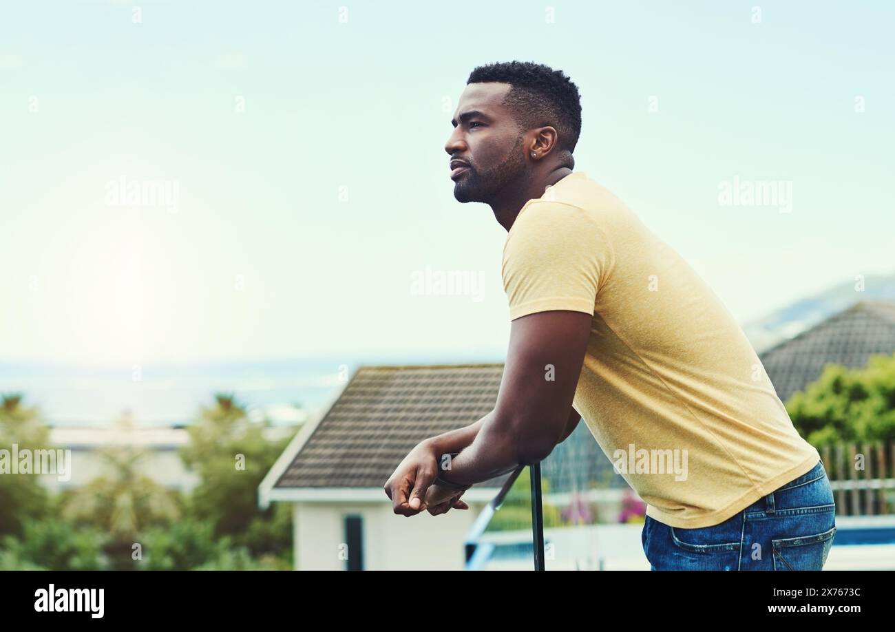 Black man, balcony and thinking to relax in outdoor, nature and weekend ...