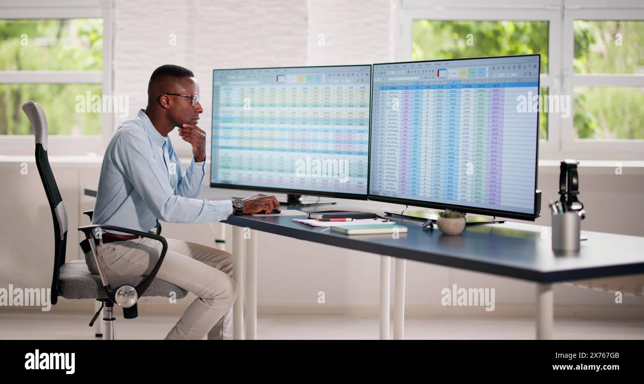Data Analyst African Man Using Spreadsheet On Computer Stock Photo - Alamy
