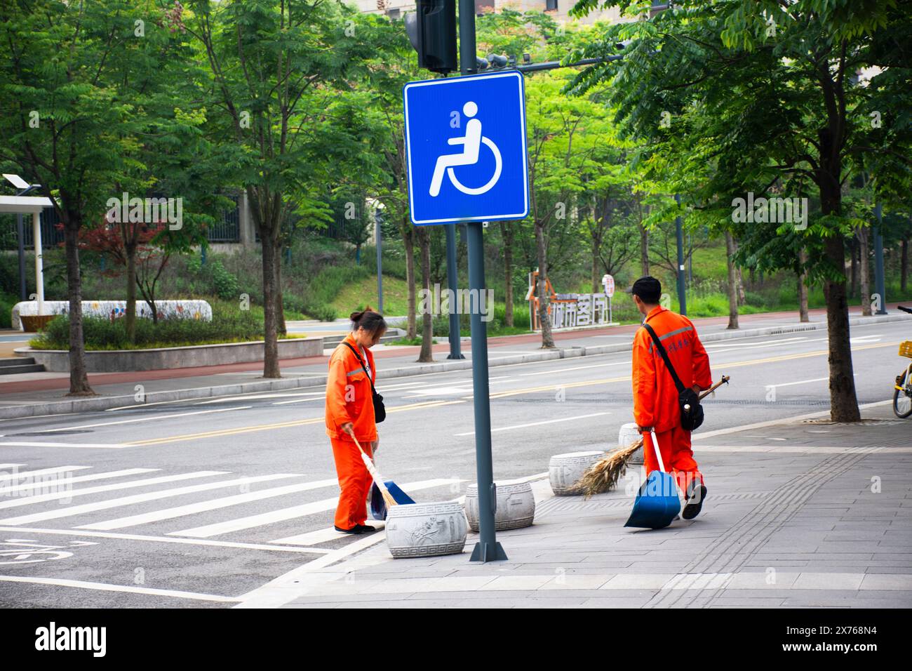 Chinese men worker people and road sweeper women use broom and dustpan ...