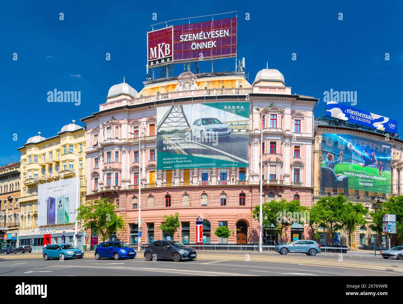 A pink historical building with advertising banners, Budapest, Hungary ...