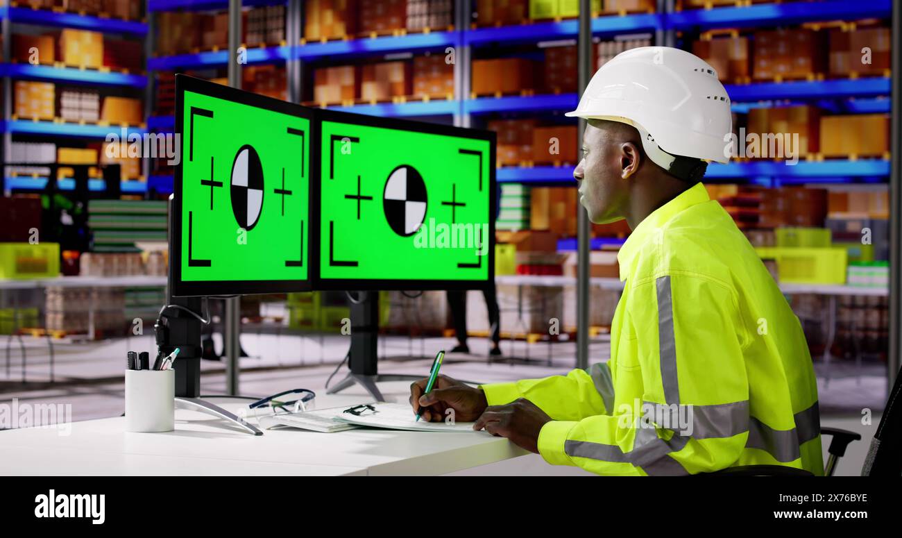 Engineer Using PC Monitor With Green Screen At Warehouse Stock Photo ...