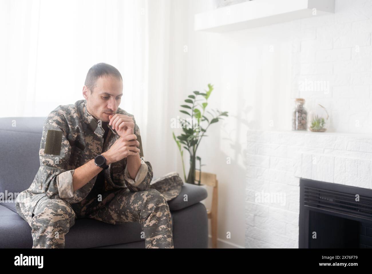Sad Soldier In Uniform Praying and sitting Stock Photo - Alamy