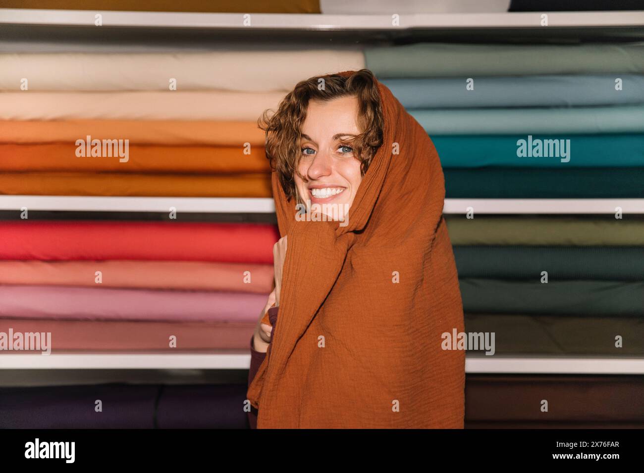 Playful Fashion Designer Wrapped in Warmth Textile Shop Stock Photo - Alamy
