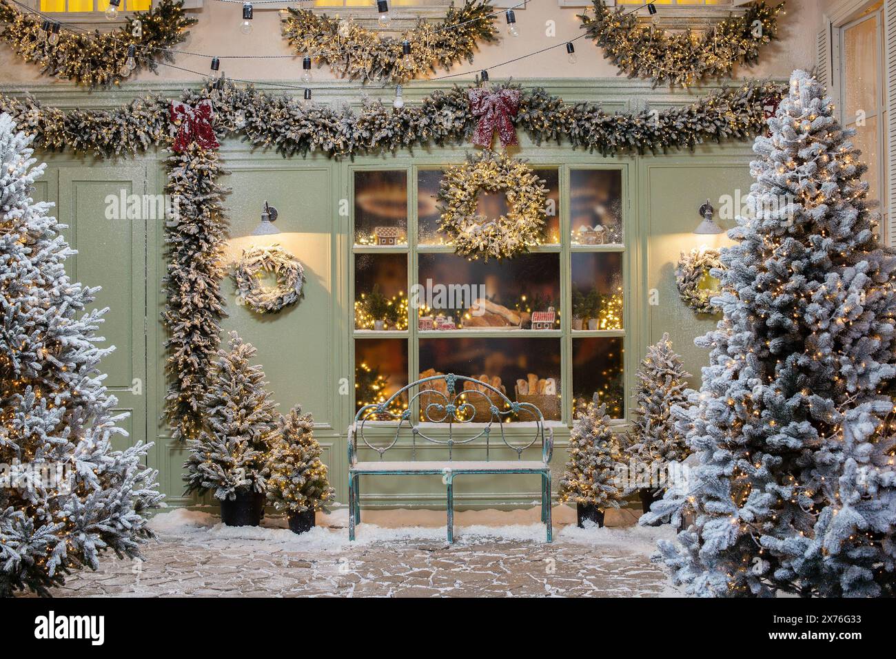 New Year's photo zone with snow near a cafe bakery. Christmas decor ...