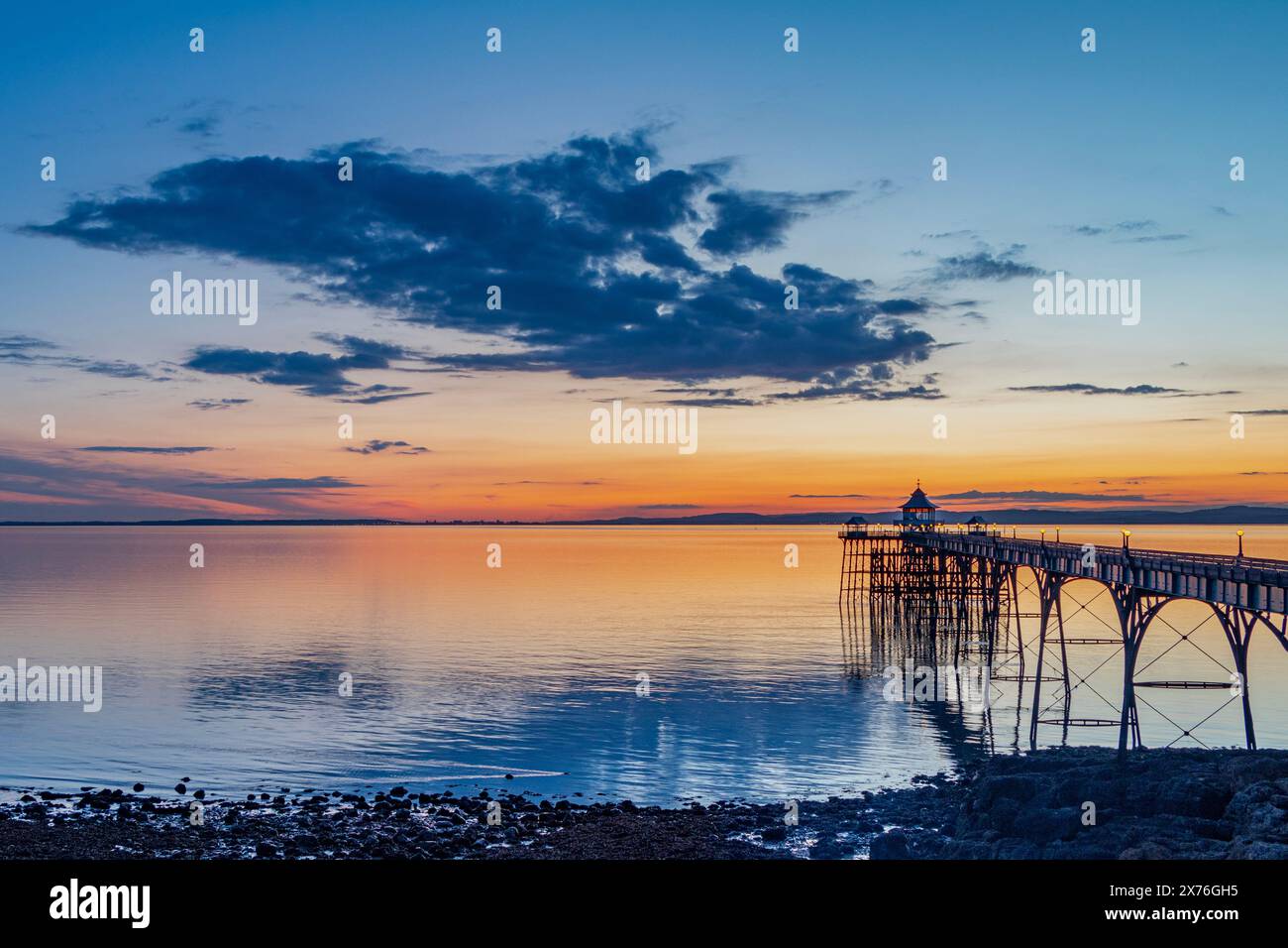 The legs of the Pier rflecting onto a calm sea Stock Photo - Alamy