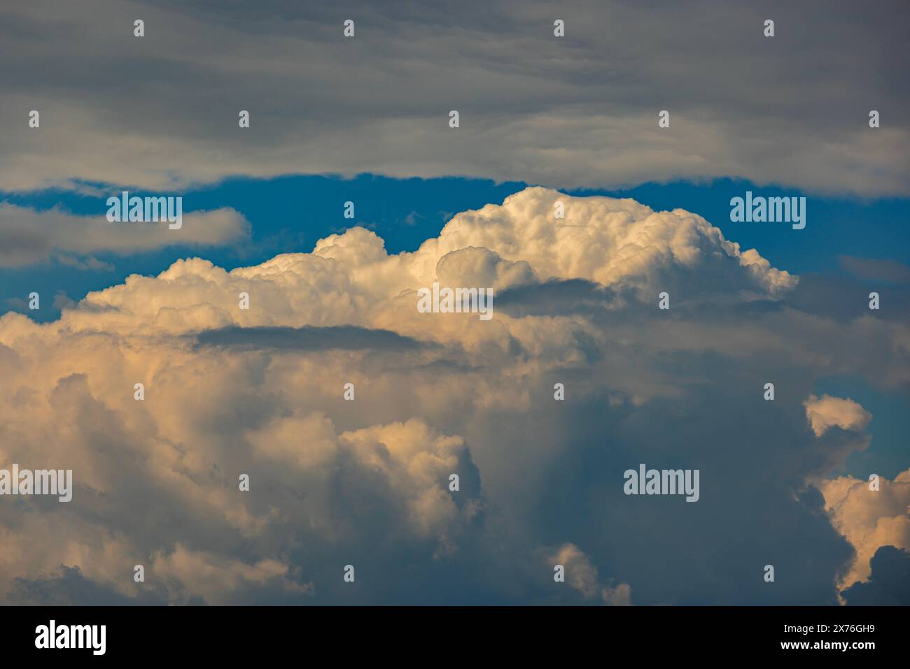 Large cumulus clouds building with a patch of blue sky Stock Photo - Alamy