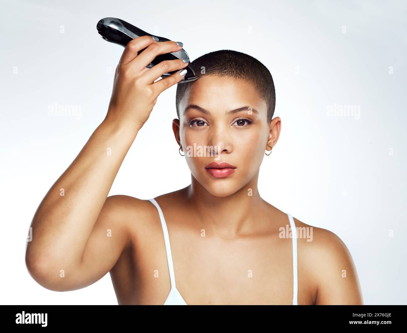 Beauty, head shave and portrait of black woman in studio on blue ...