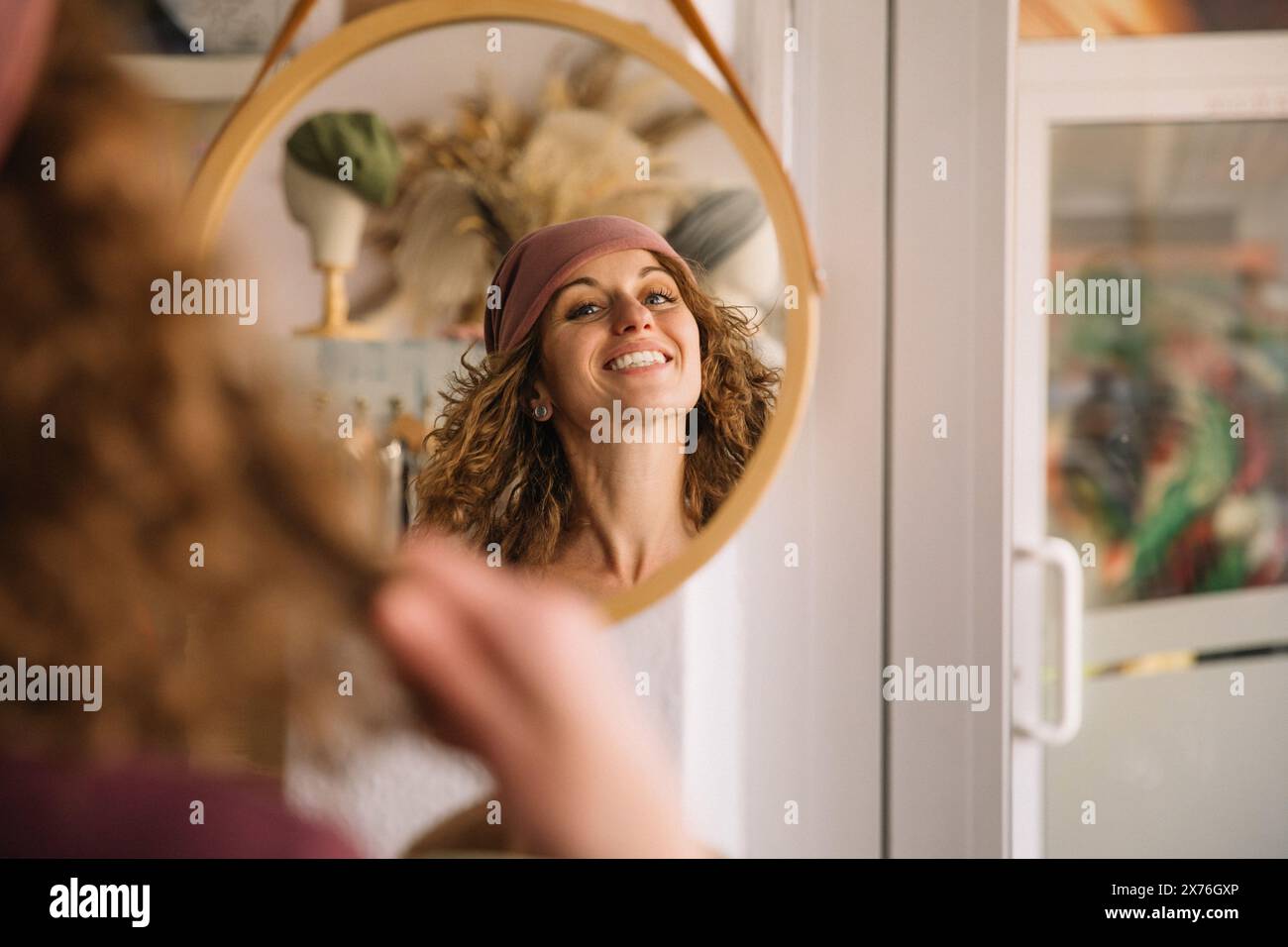 Woman fashion designer joyfully smiles as she adjusts her stylish ...