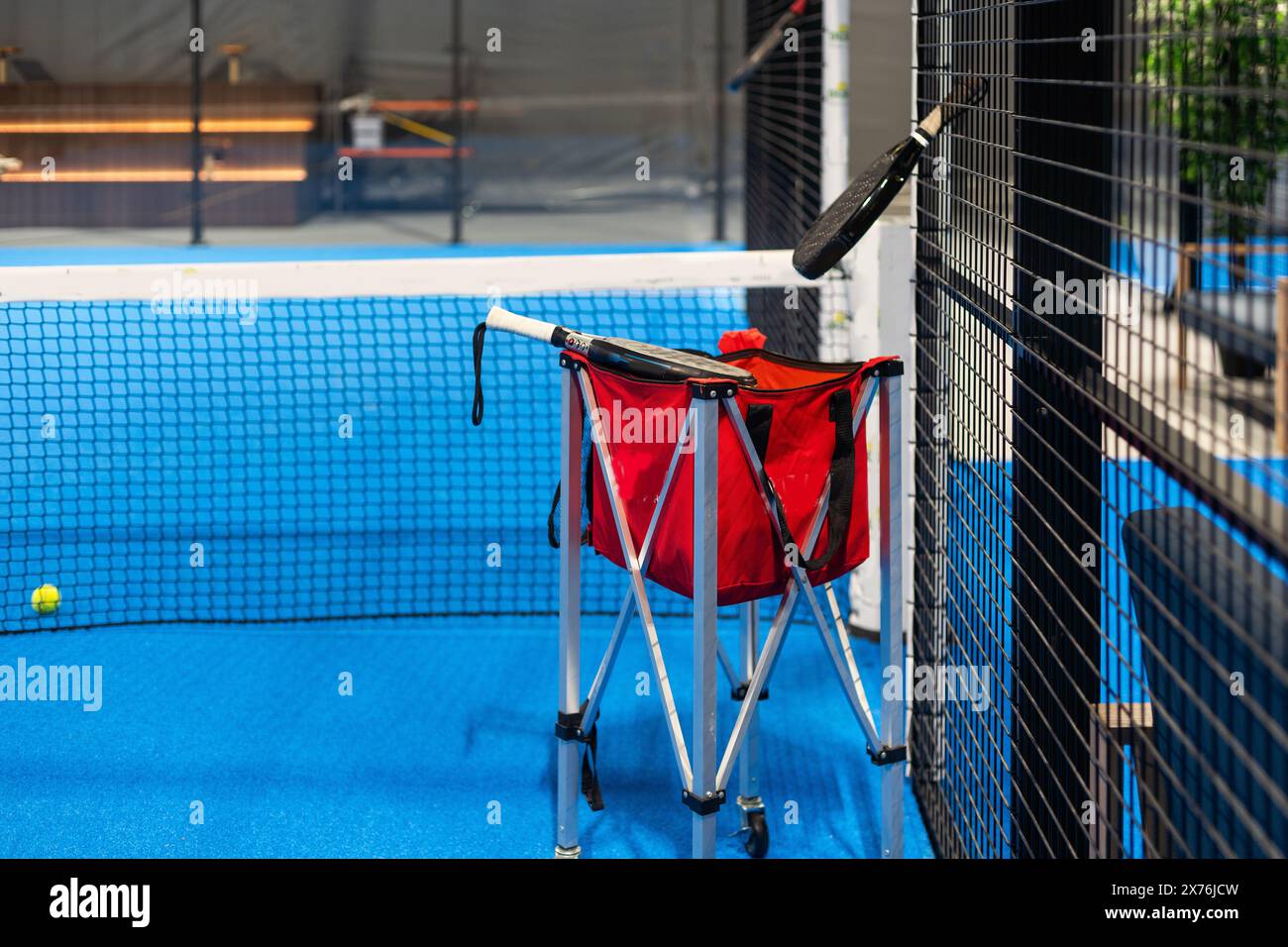 Paddle tennis rackets, balls and basket in court still life Stock Photo ...