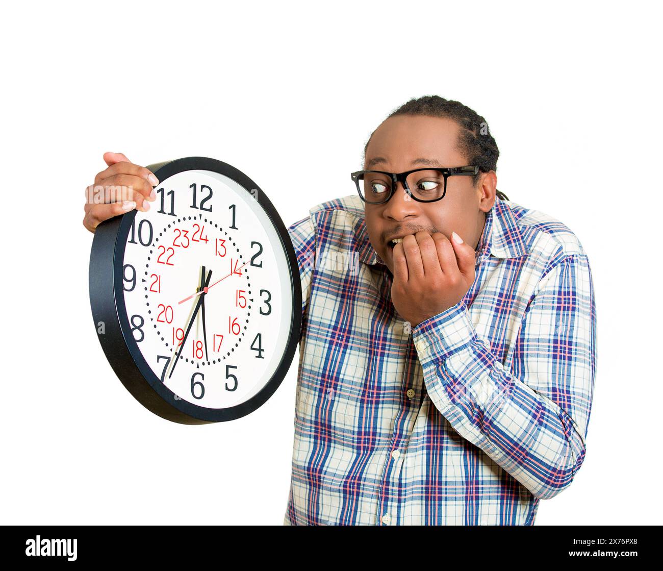 Stressed young man running out of time looking at wall clock Stock ...