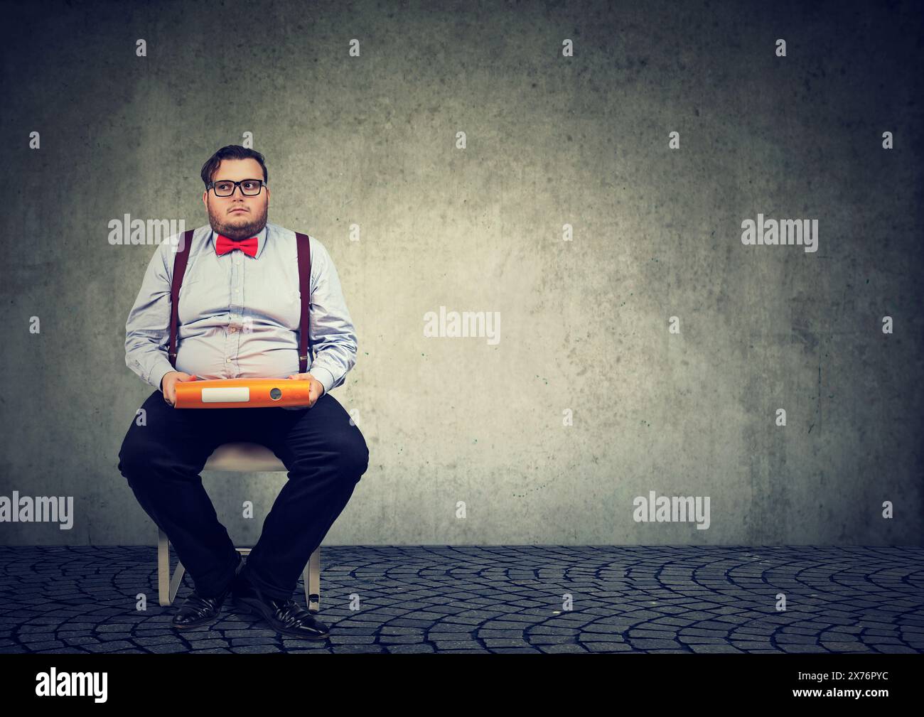 A job candidate young man sitting on a chair with big folder Stock ...