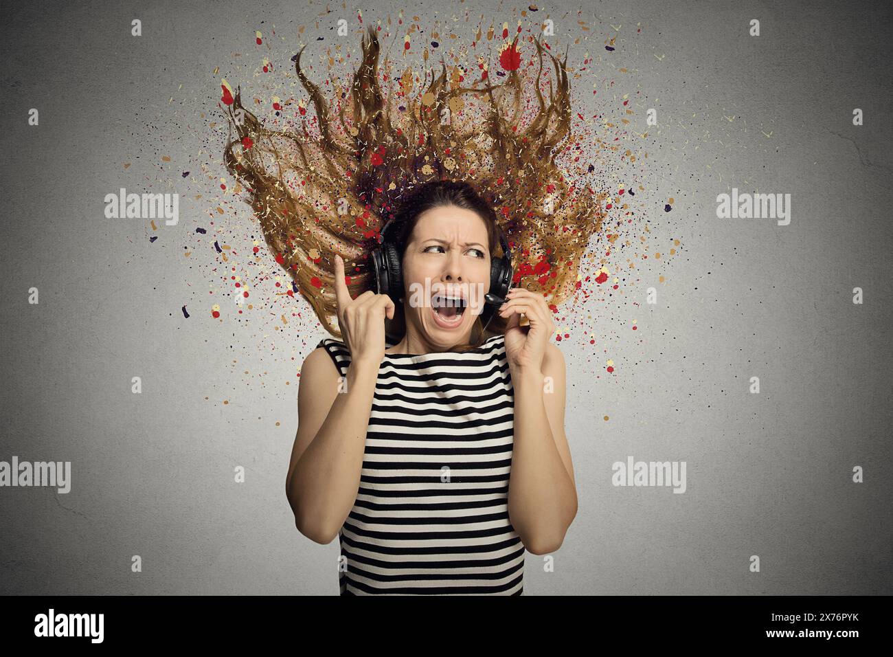 Screaming young woman with headset on gray background Stock Photo - Alamy