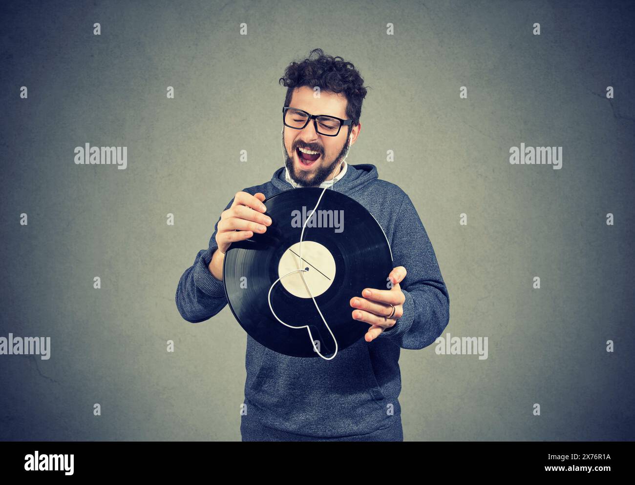 Happy singing man listening music on a vinyl record Stock Photo - Alamy