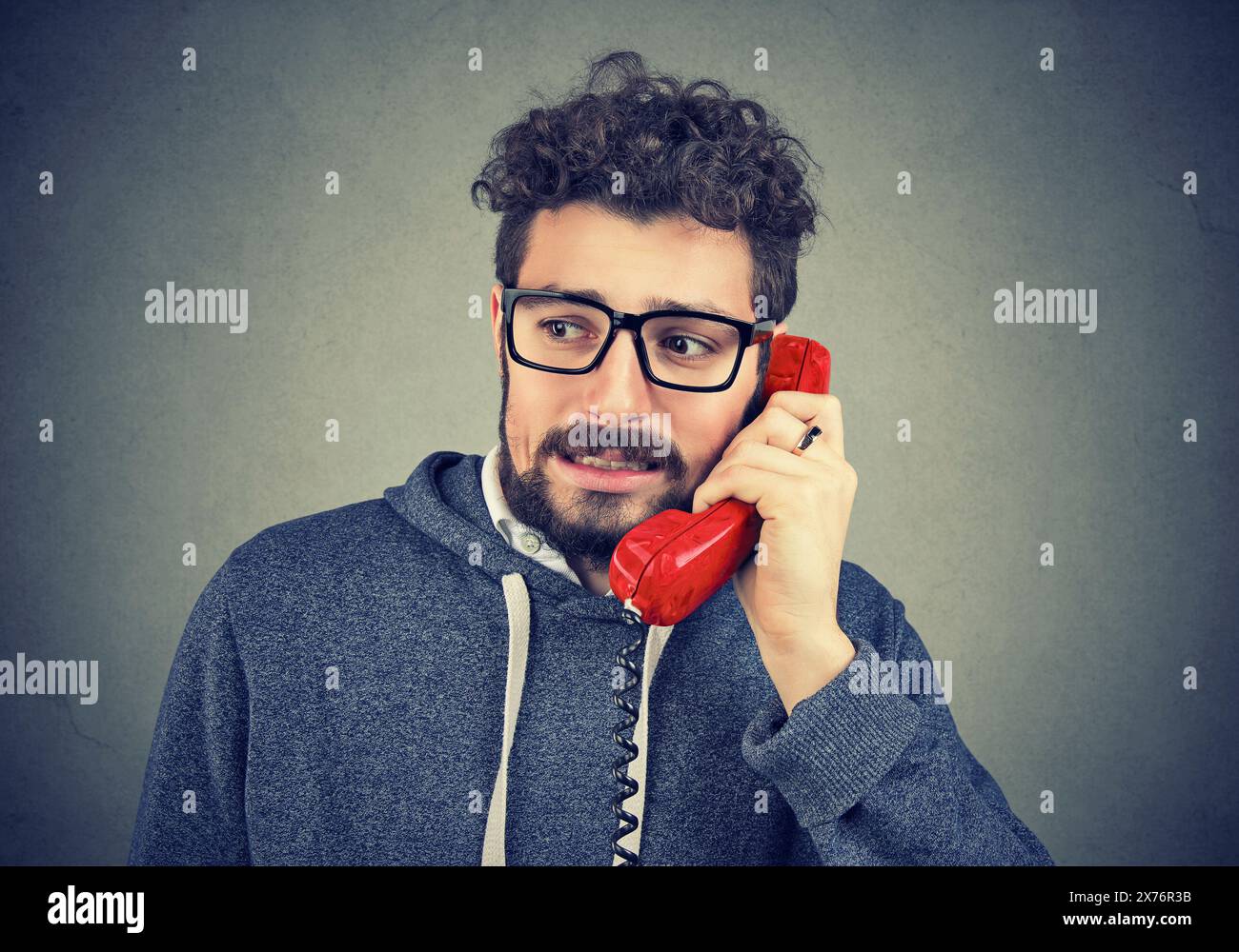 man talking on the phone, feeling awkward and embarrassed Stock Photo ...