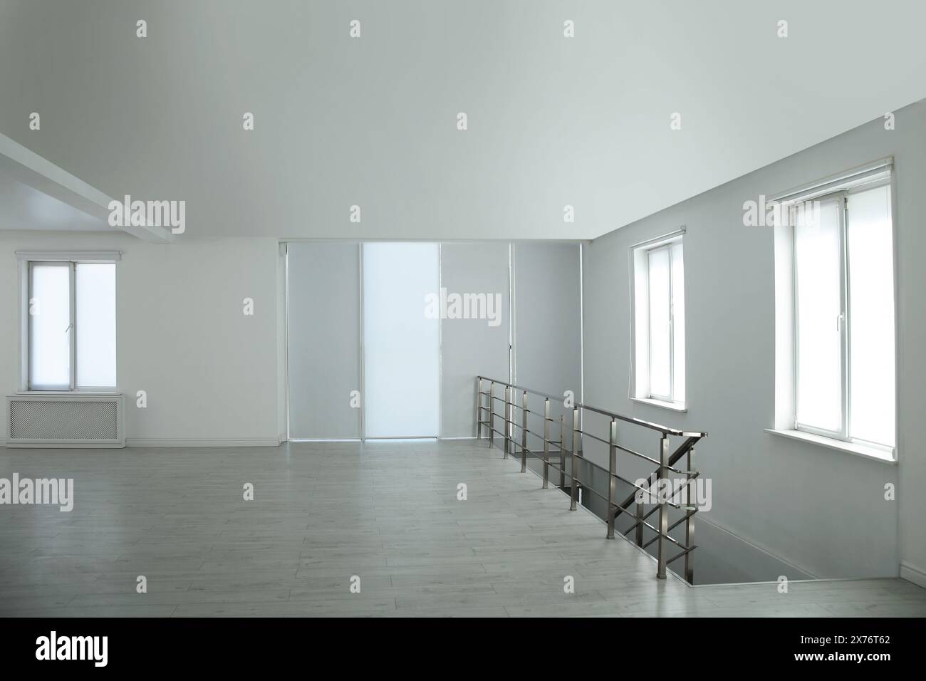 Large empty hall with windows and railings Stock Photo - Alamy