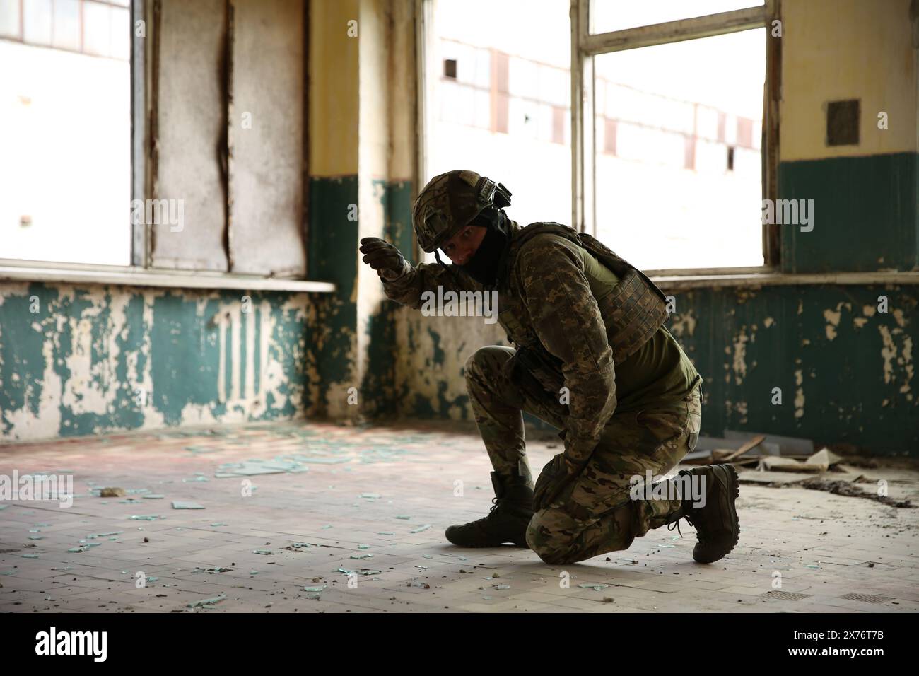 Military mission. Soldier in uniform inside abandoned building, space ...