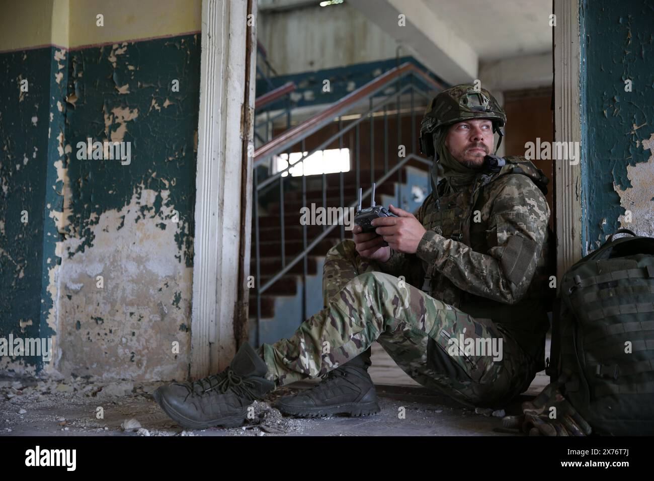 Military mission. Soldier in uniform with drone controller inside ...