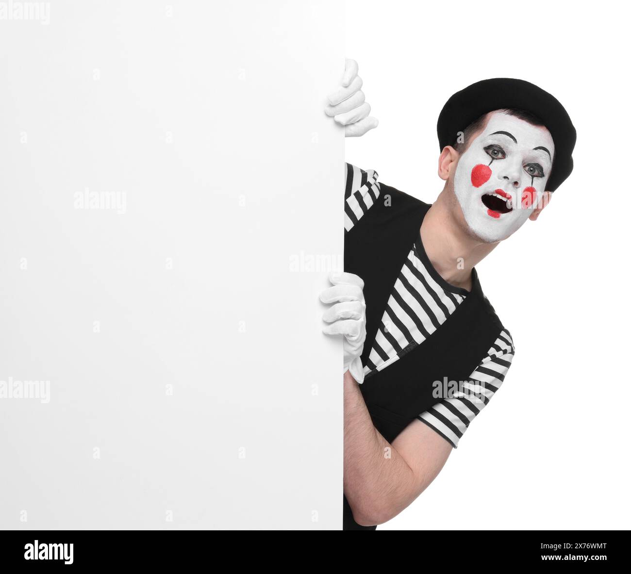 Funny mime artist peeking out of blank poster on white background Stock ...