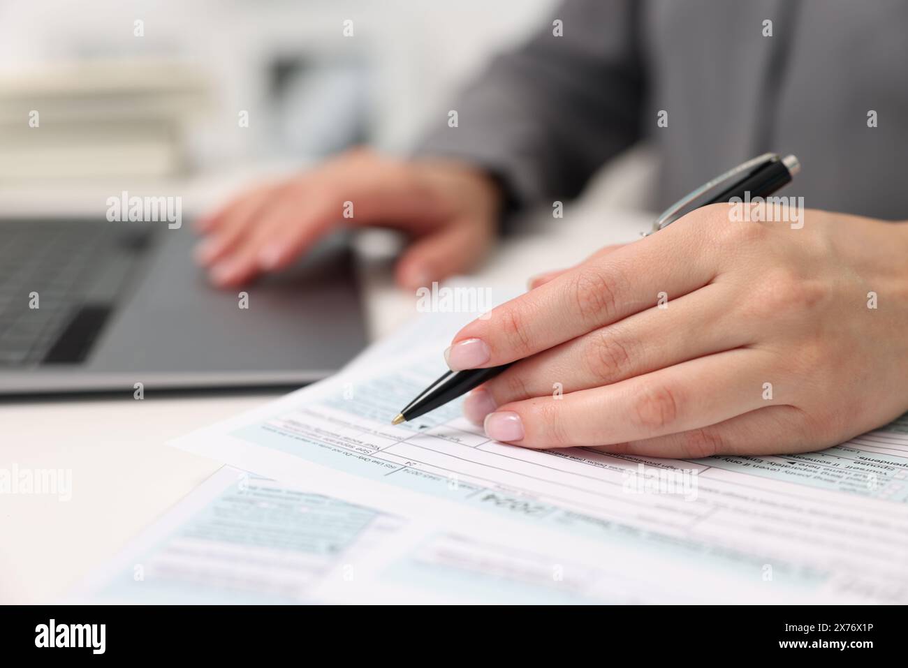 Secretary doing paperwork at table in office, closeup Stock Photo - Alamy