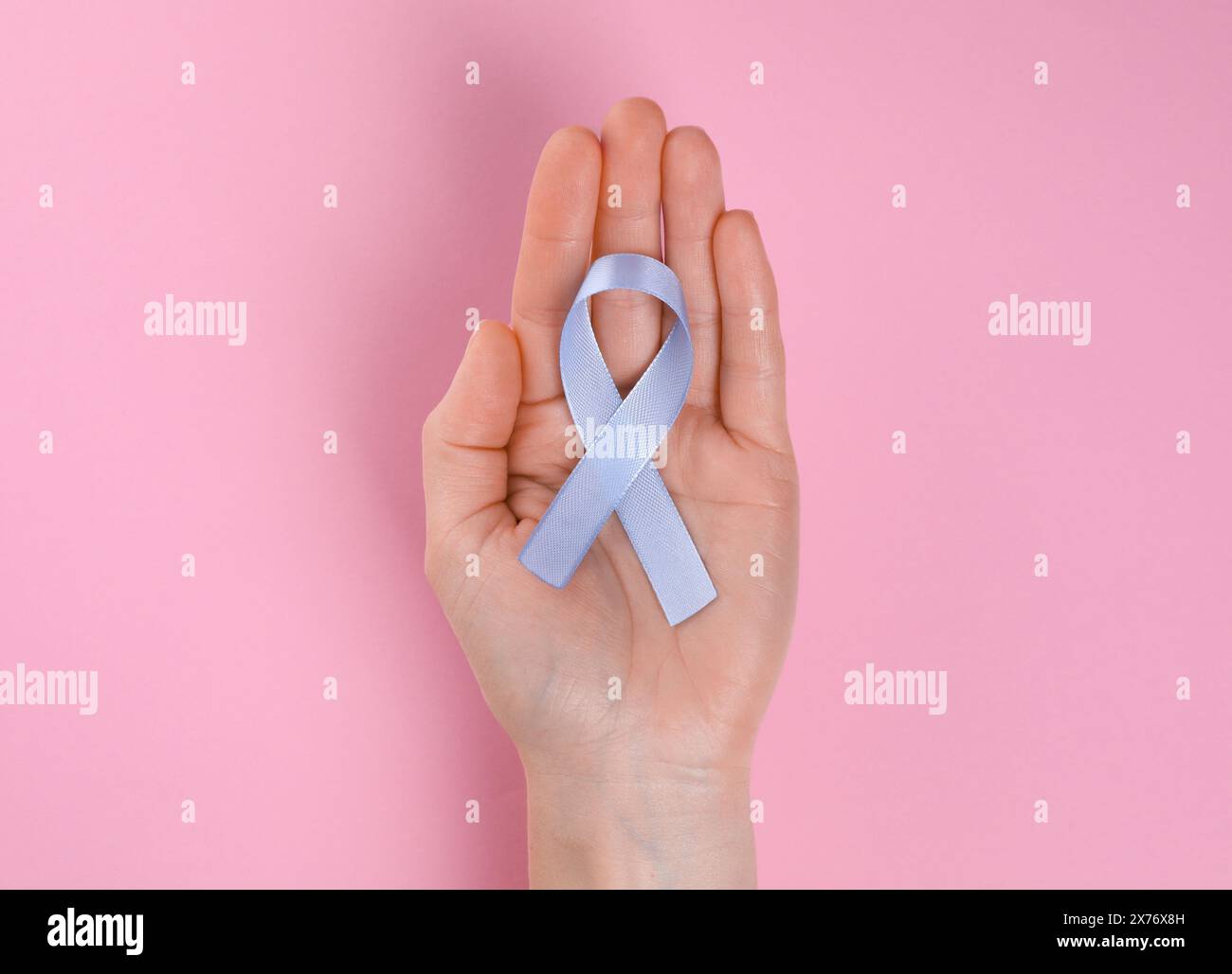 International Psoriasis Day. Woman with light blue ribbon as symbol of ...