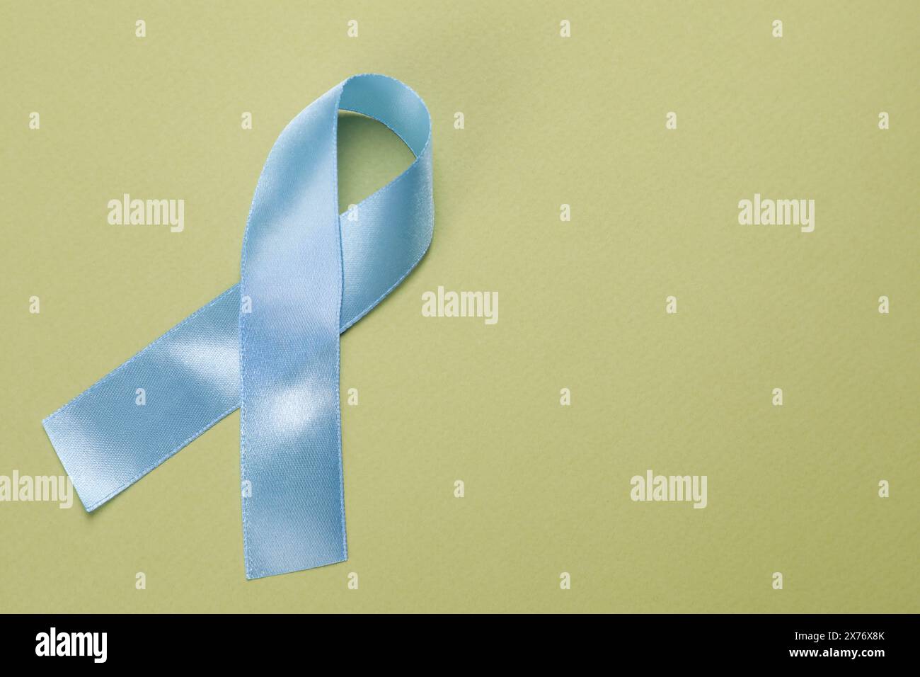 International Psoriasis Day. Ribbon as symbol of support on green ...