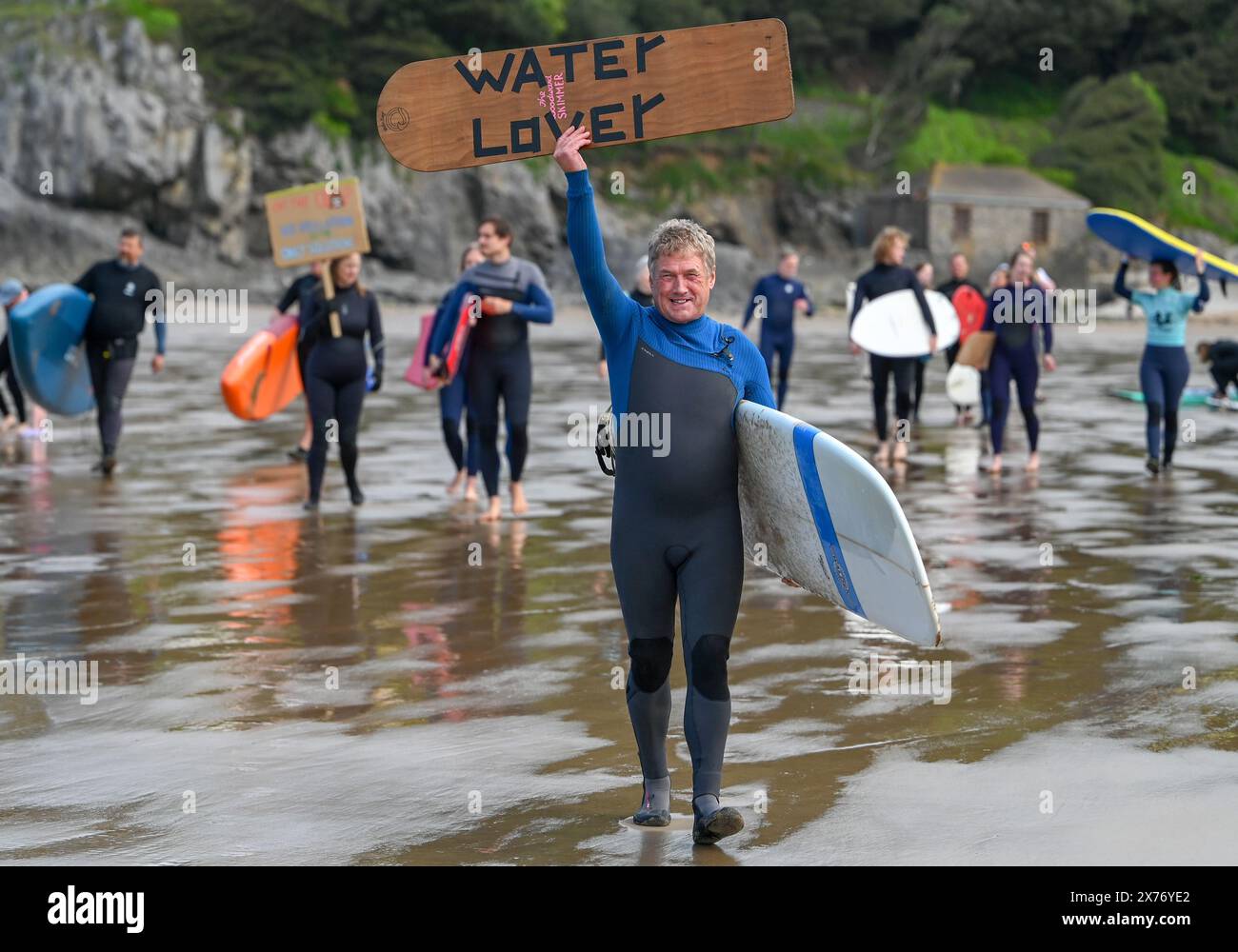 People take part in a paddle-out at Caswell Bay in Swansea, part of a ...