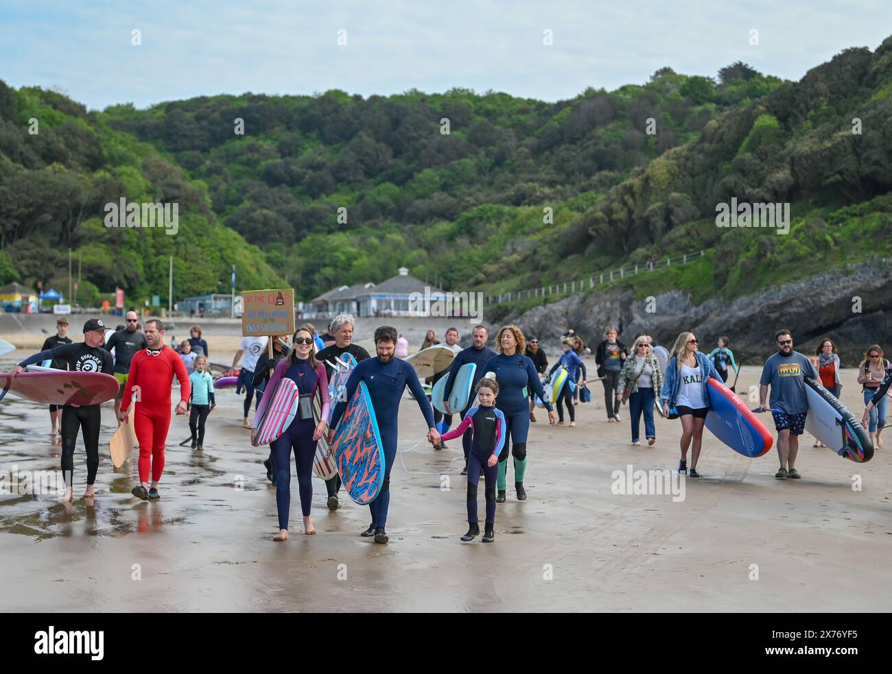 People take part in a paddle-out at Caswell Bay in Swansea, part of a ...