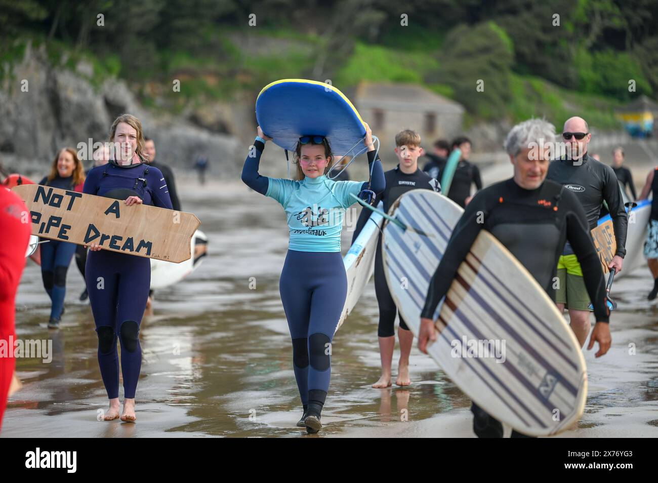 People take part in a paddle-out at Caswell Bay in Swansea, part of a ...