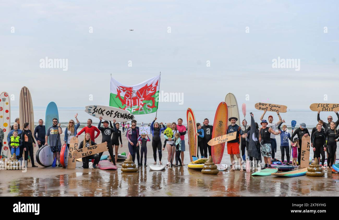 People take part in a paddle-out at Caswell Bay in Swansea, part of a ...