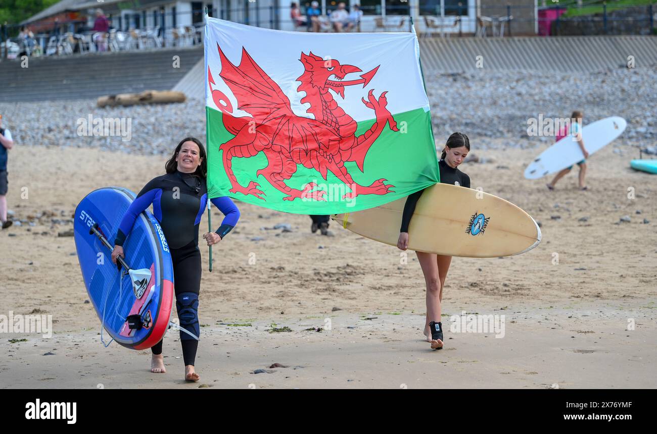 People take part in a paddle-out at Caswell Bay in Swansea, part of a ...