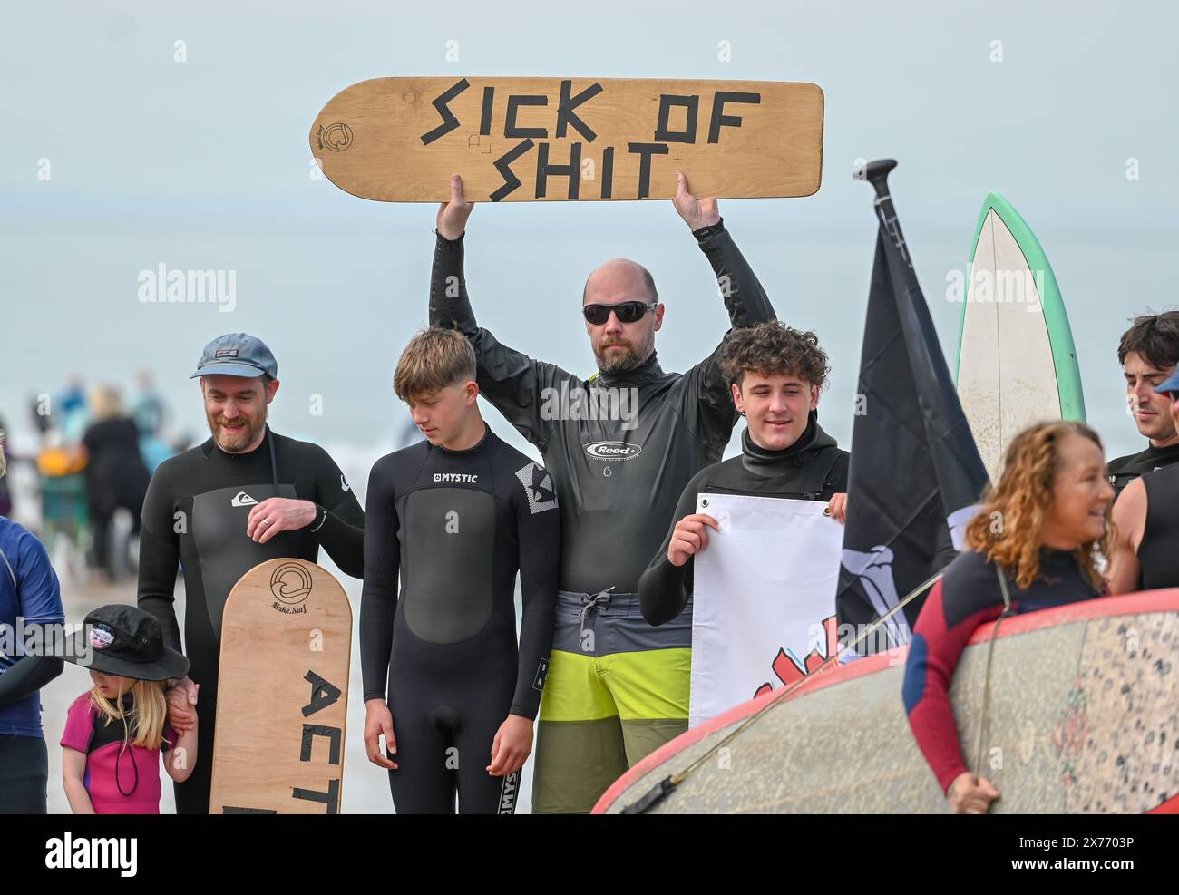 People take part in a paddle-out at Caswell Bay in Swansea, part of a ...