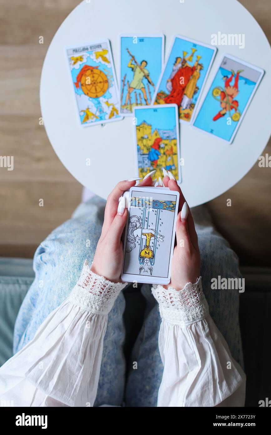 Tarot card in hands. White magic, attributes for witch. Esoteric ...