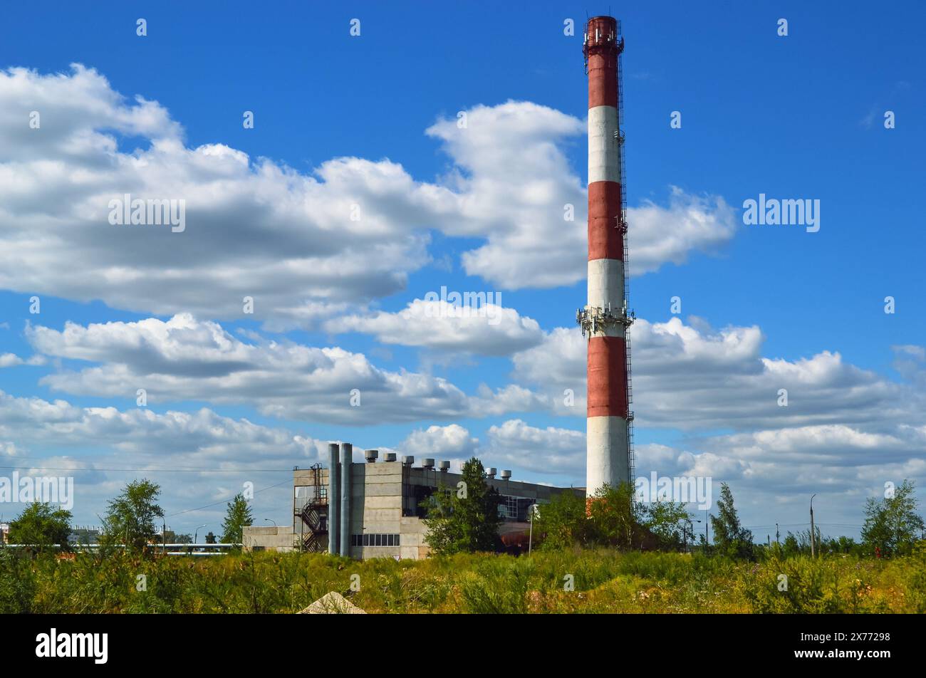 Tall striped red and white chimney of a boiler house against the ...
