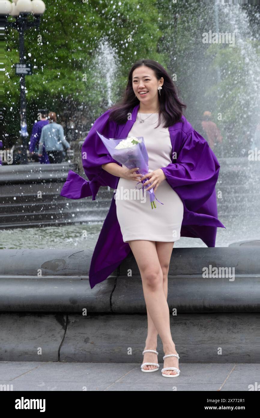 After the NYU 2024 graduation ceremony a beautiful Asian American woman poses for photos while ...
