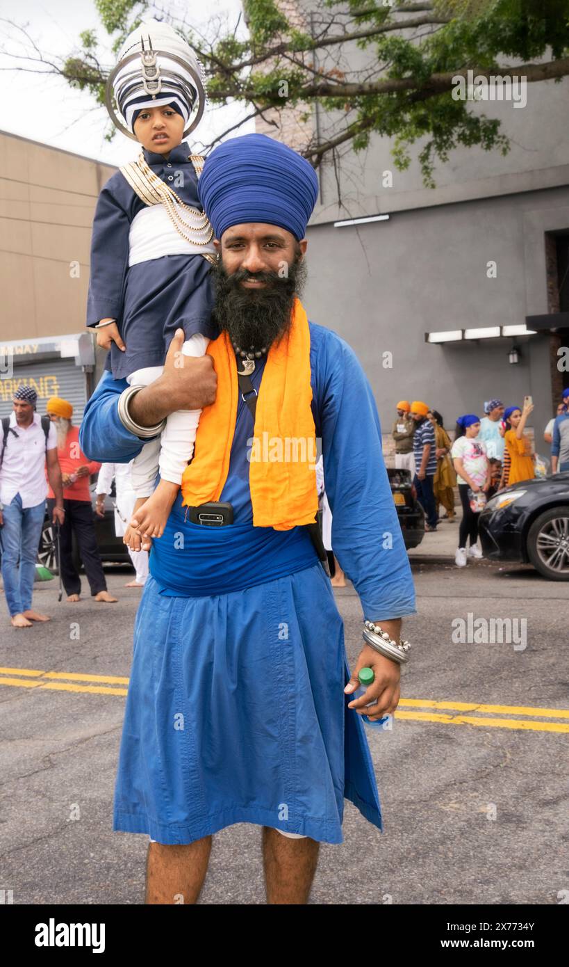 A Sikh father dressed in blue, carries his cute daughter during the ...