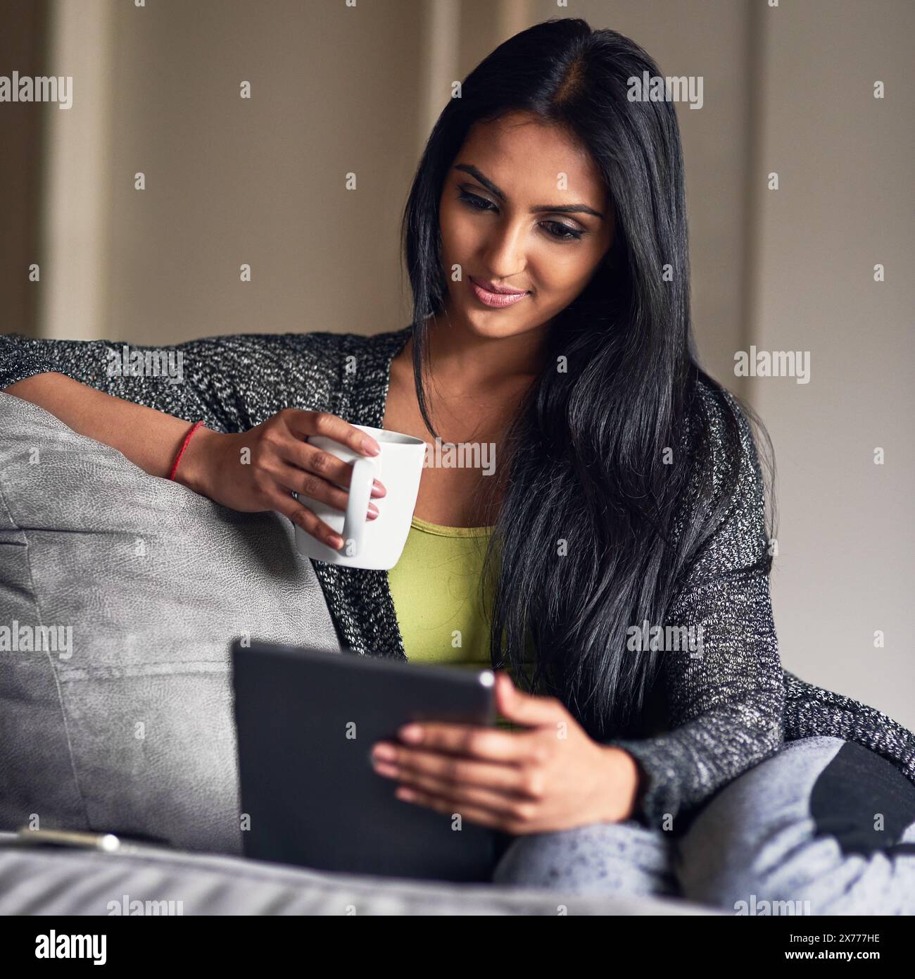 Couch, rest and girl with tablet, reading and relax in living room ...