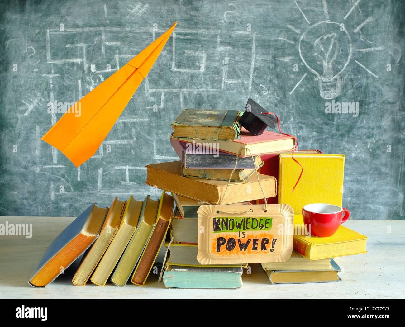knowledge is power, arrangement of books, a paper plane and sign for ...
