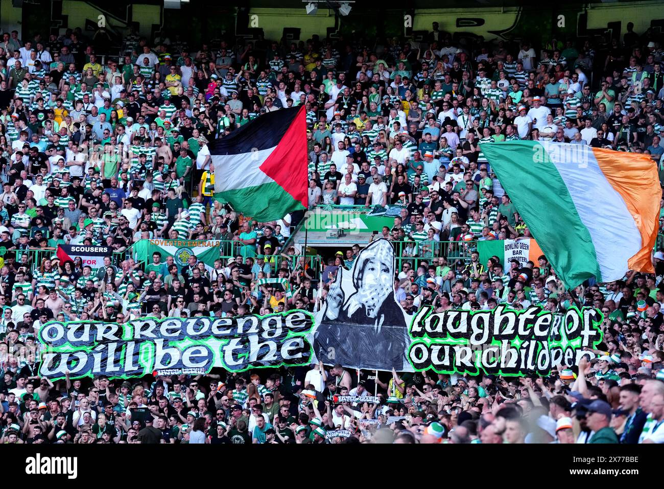 Celtic fans hold up banners and flags in the stands during the cinch ...