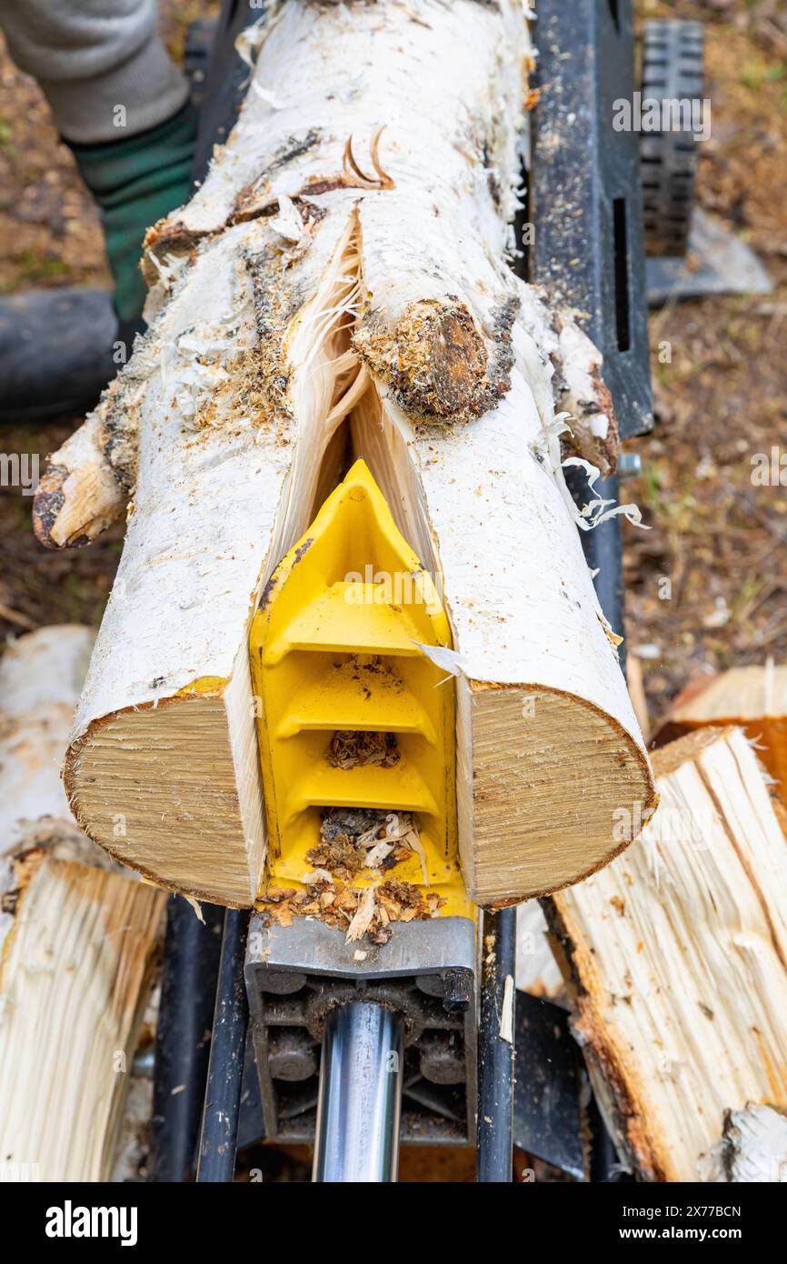 The high-speed process of splitting a log with an electric wood ...