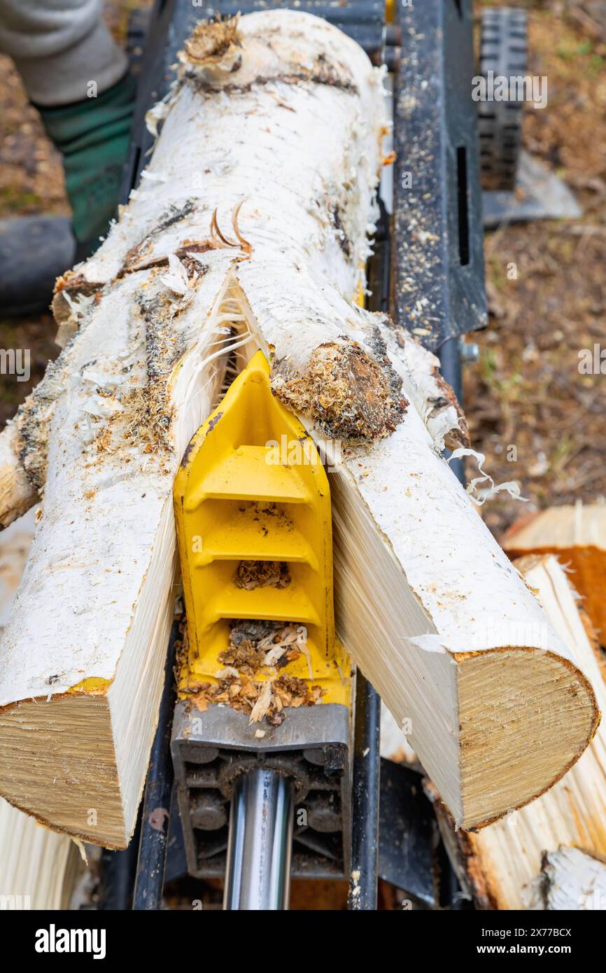 The high-speed process of splitting a log with an electric wood ...