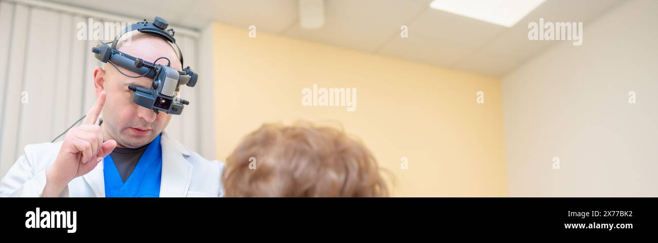 In a clinical setting, an ophthalmologist examines the patient's eyes ...