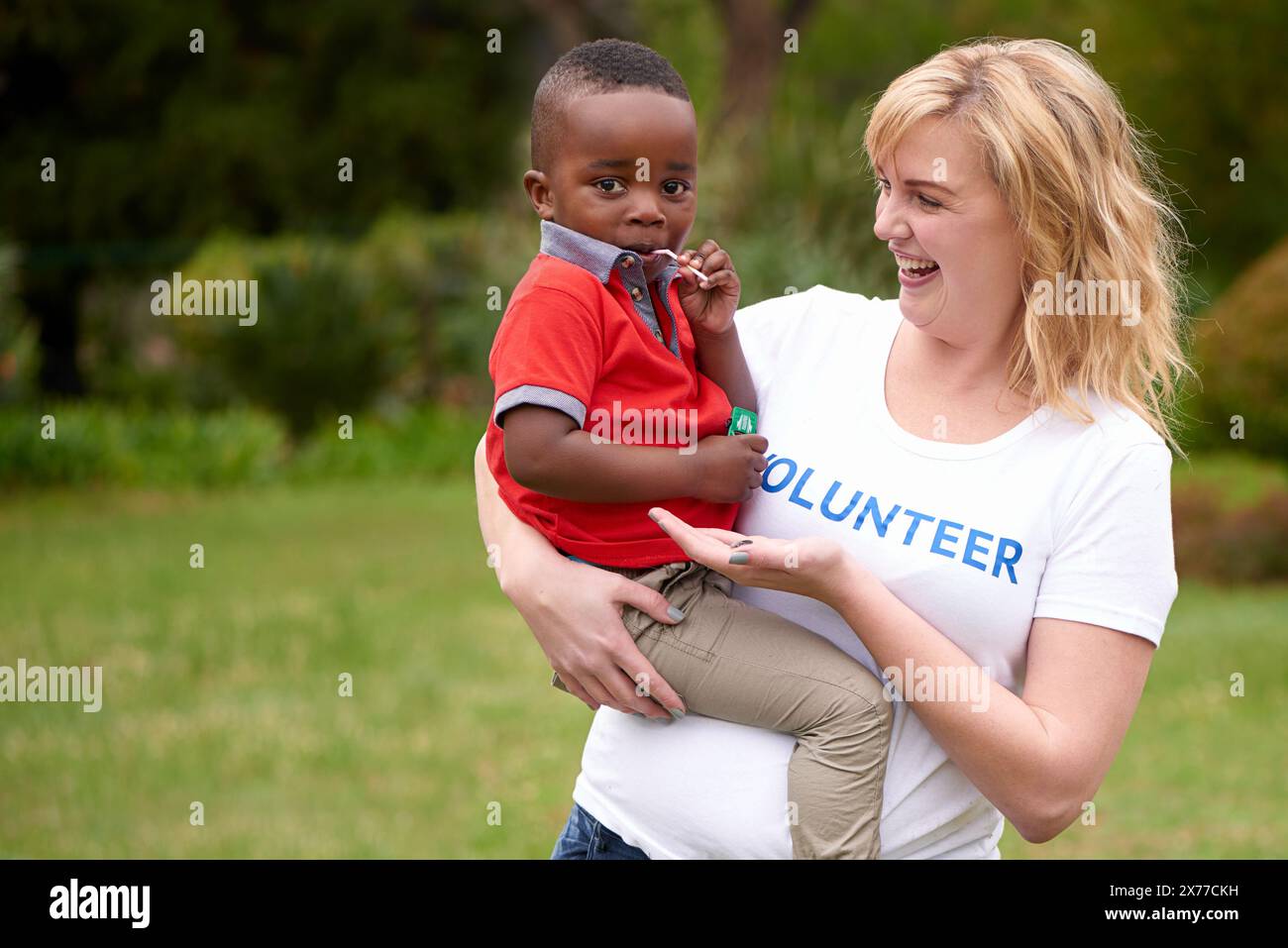 Child, volunteer and happy woman at charity in countryside for kids and ...