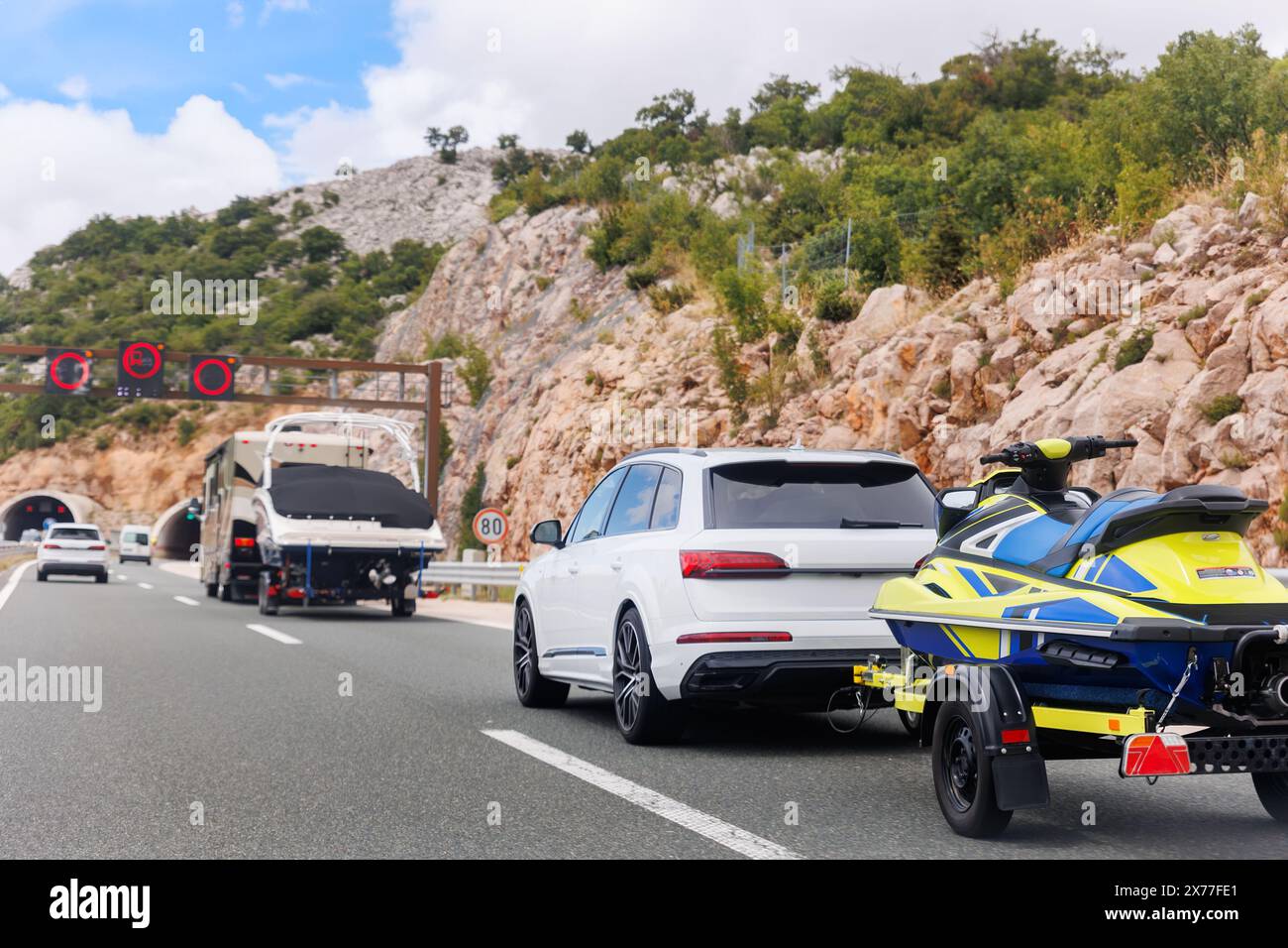 Modern luxury SUV towing jet ski trailer carrier go river lake sea ...